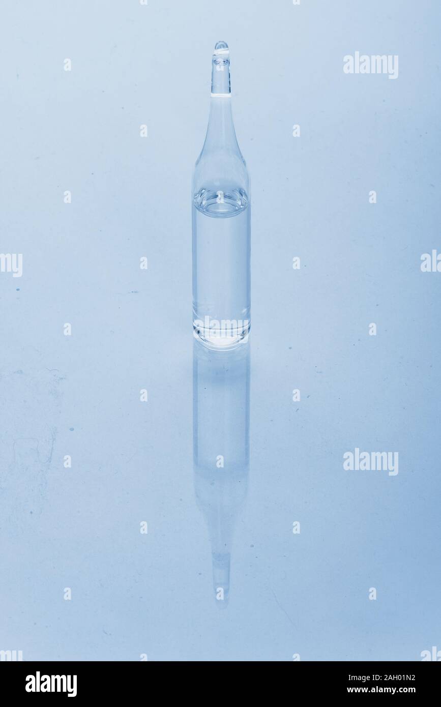 Glass medical ampoule vial for injection. Medicine is dry white drug ...