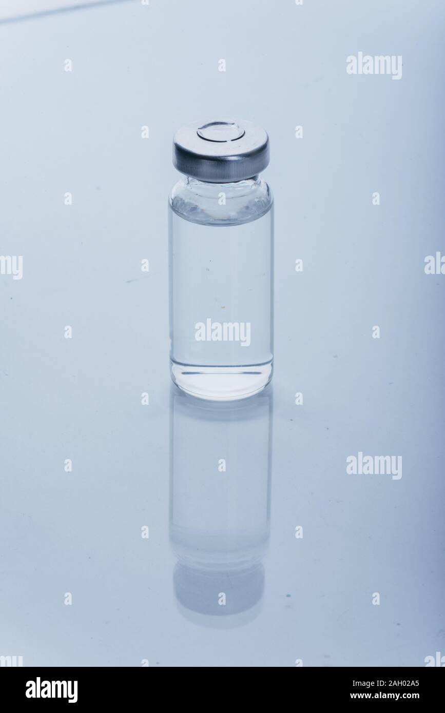 Glass medical ampoule vial for injection. Medicine is dry white drug ...