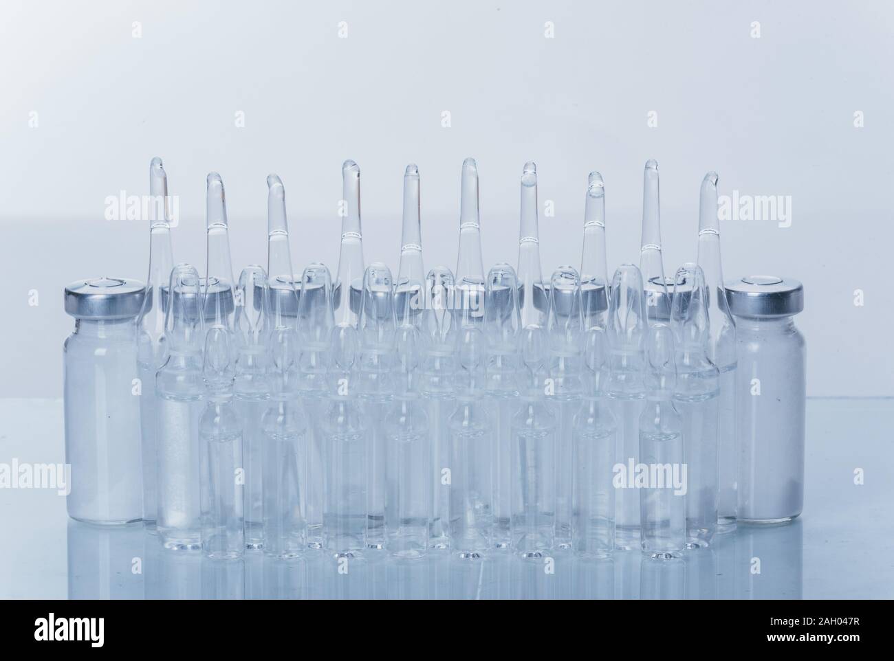 Glass medical ampoule vial for injection. Medicine is dry white drug ...