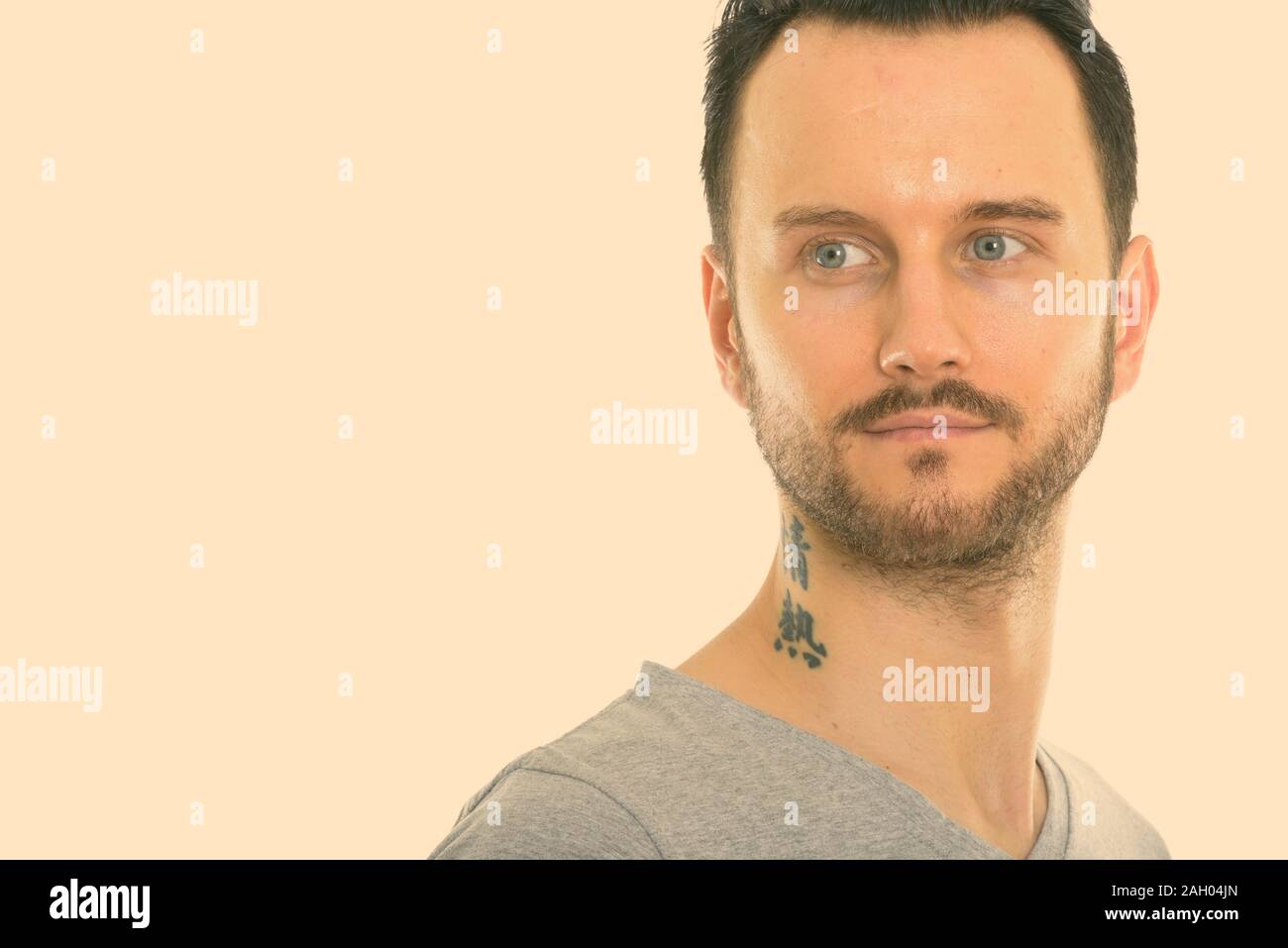 Close up of young man thinking while looking back Stock Photo - Alamy