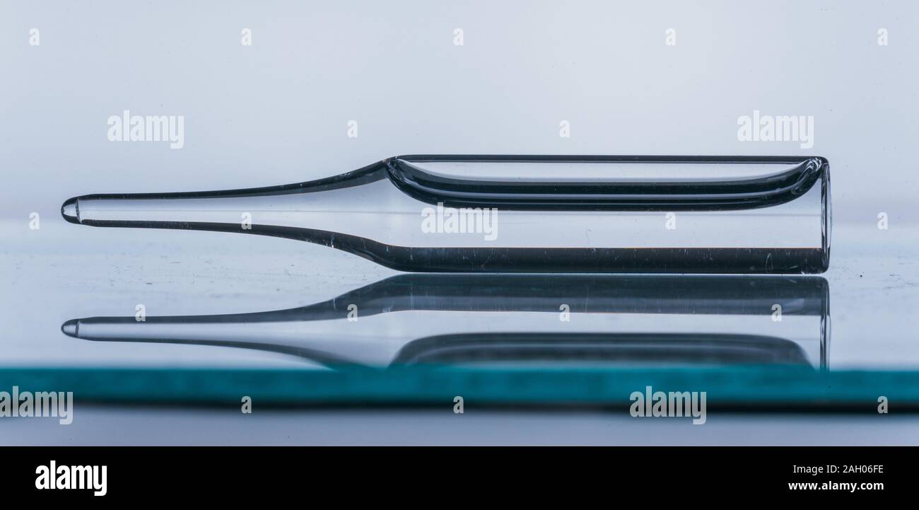 Glass medical ampoule vial for injection. Medicine is dry white drug ...