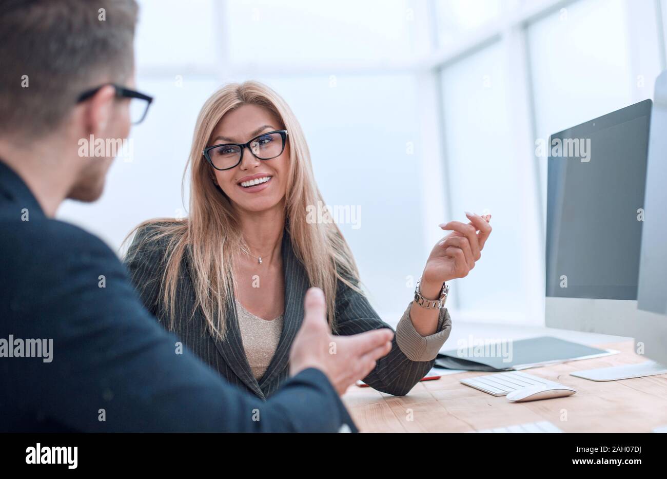 business colleagues discussing work tasks sitting at a computer table ...