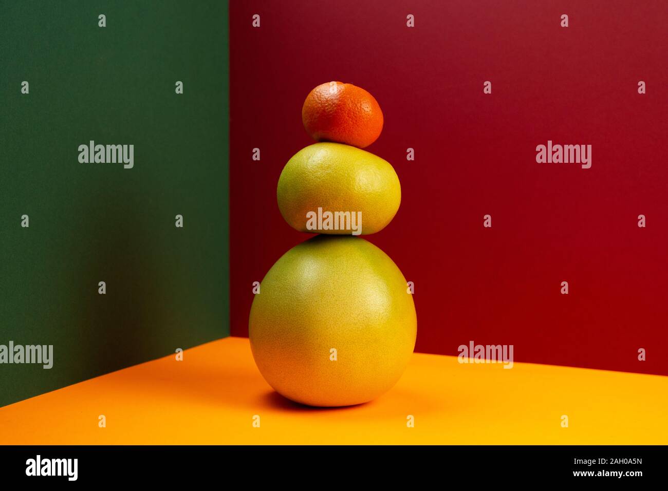 Multicolored geometric composition with various citrus fruits on a ...