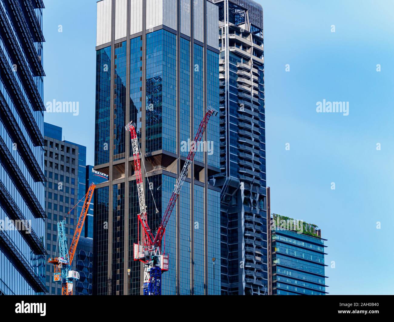 SINGAPORE – 13 APR 2019 – High-rise building cranes against a backdrop ...
