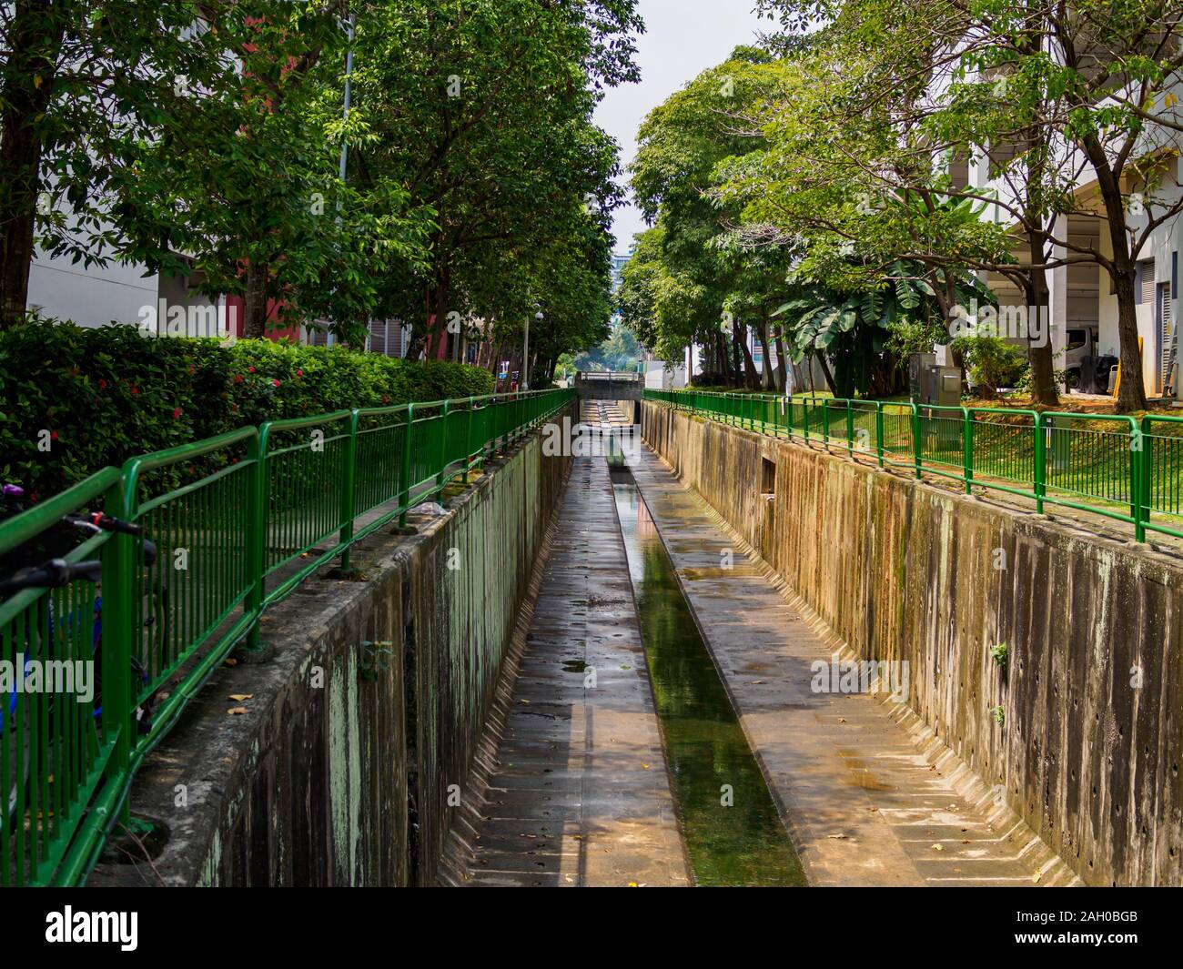 Tree lined water canal channel in a HDB residential housing estate in ...
