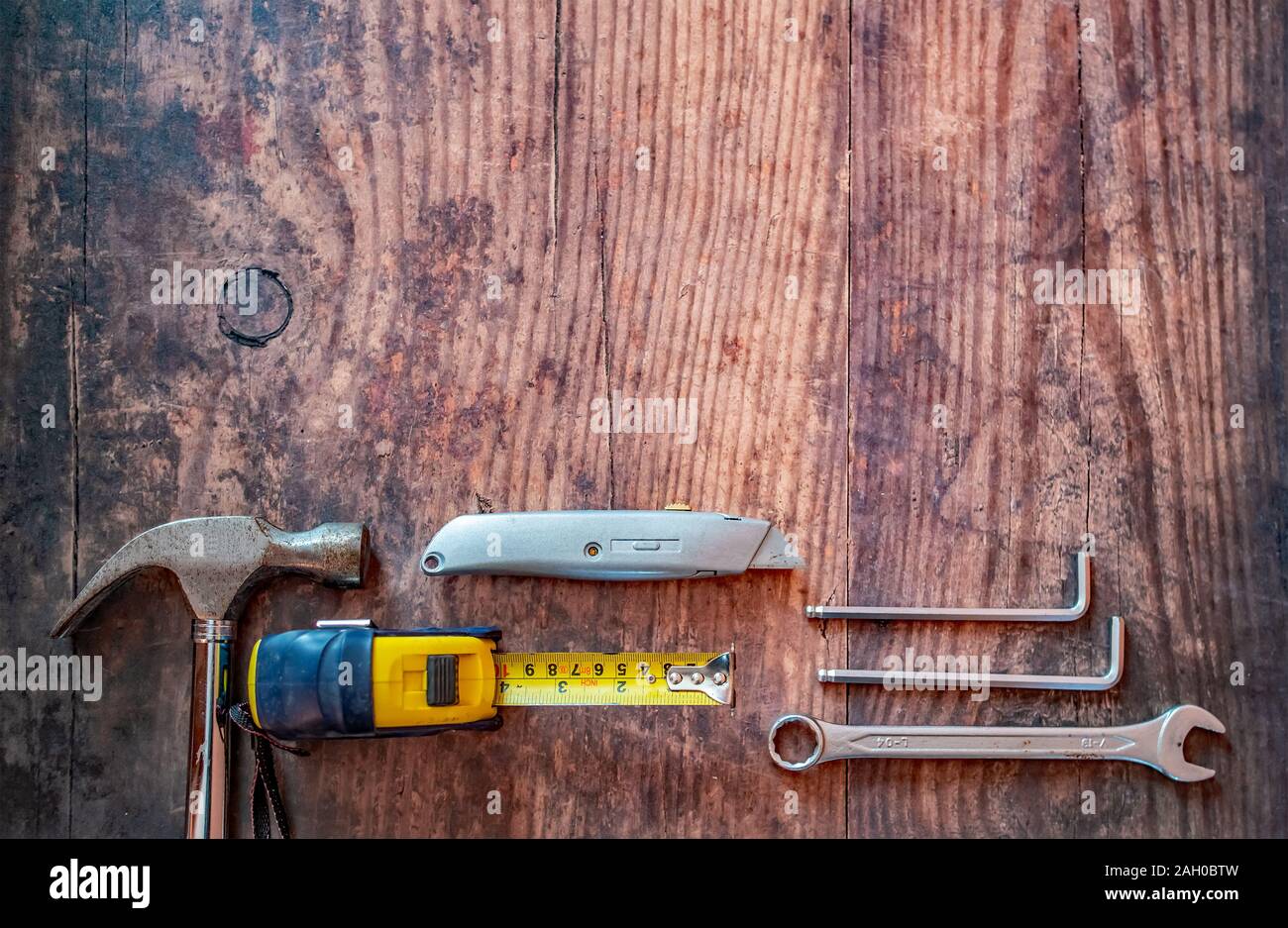 Top down view of various DIY tools on a wooden background with copy ...