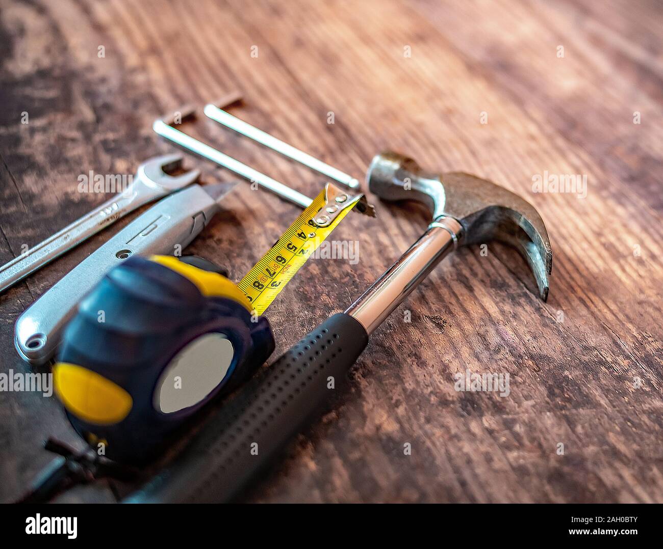 Selective focus on DIY tools on a plain wood background with copy space ...