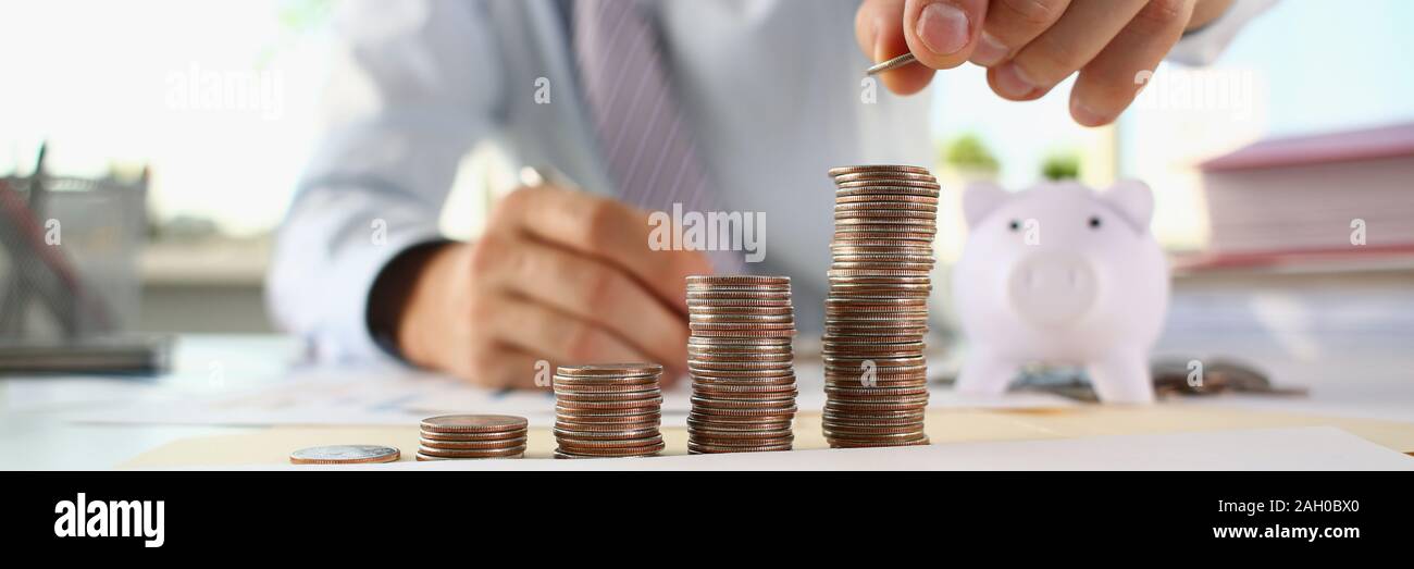 Hand businessman putting pin money Stock Photo - Alamy