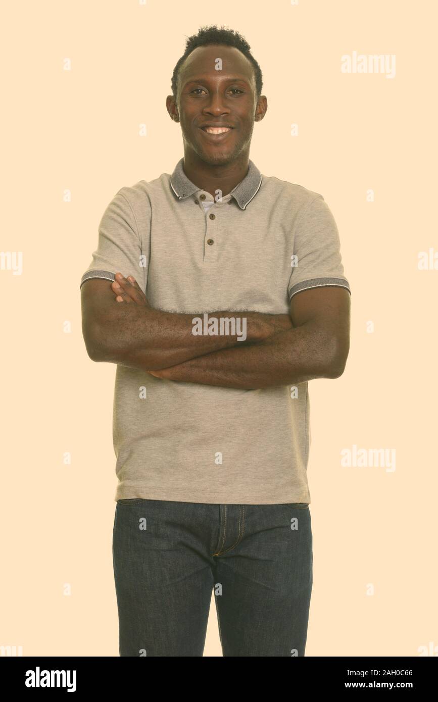 Young happy black African man smiling with arms crossed Stock Photo - Alamy