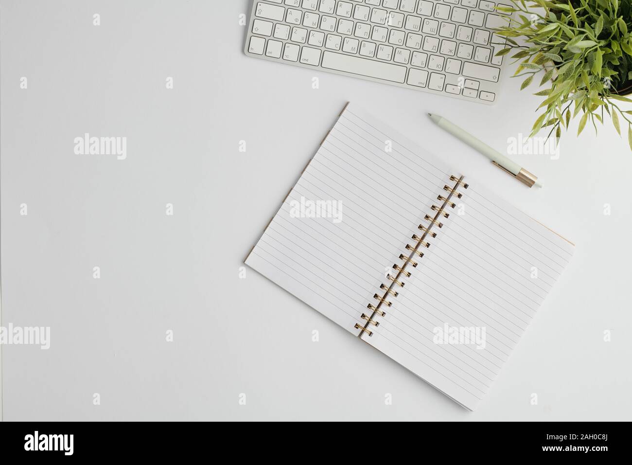 Flat layout with pen, computer keypad, open notebook with blank pages ...