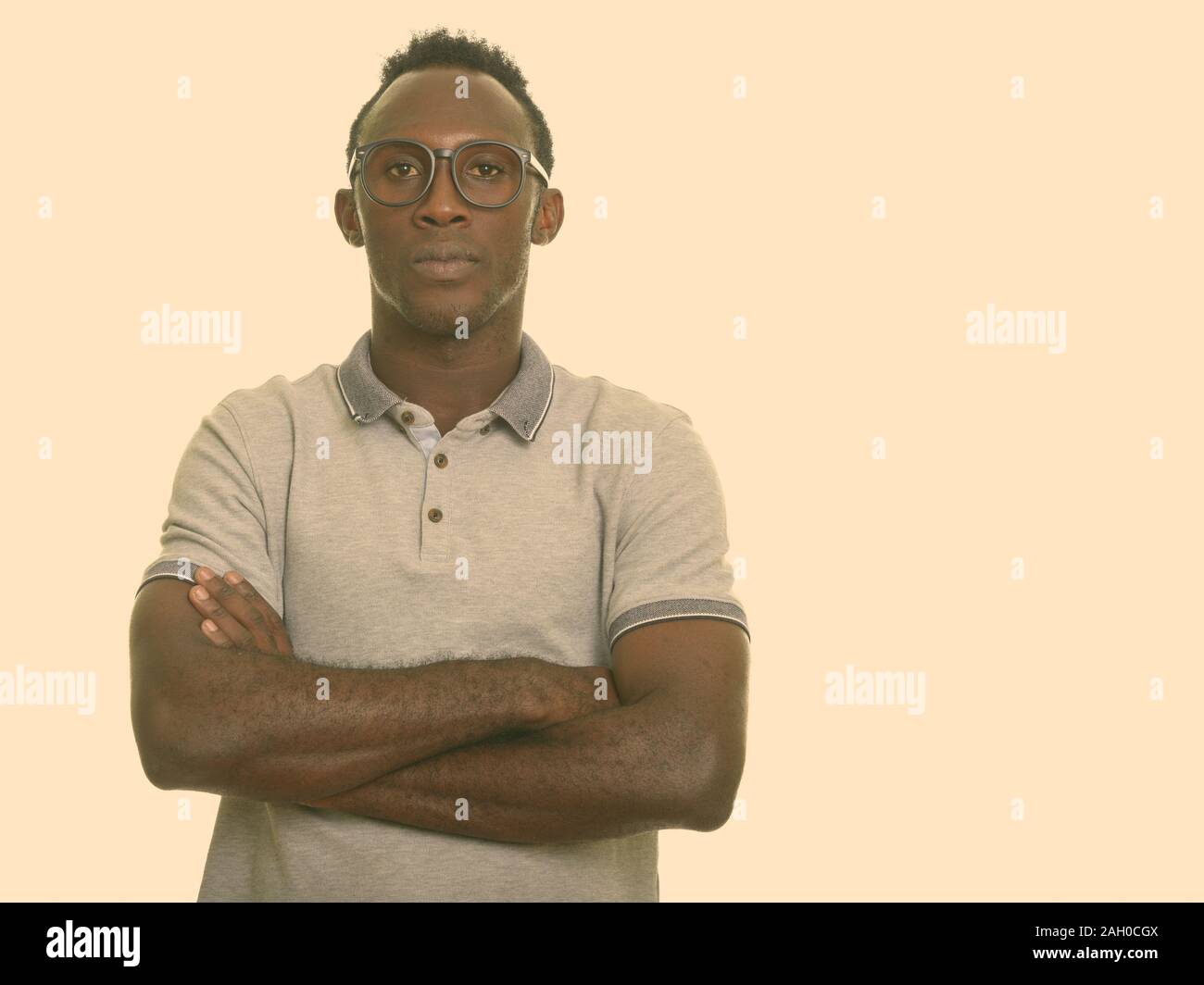 Young black African man with arms crossed Stock Photo - Alamy