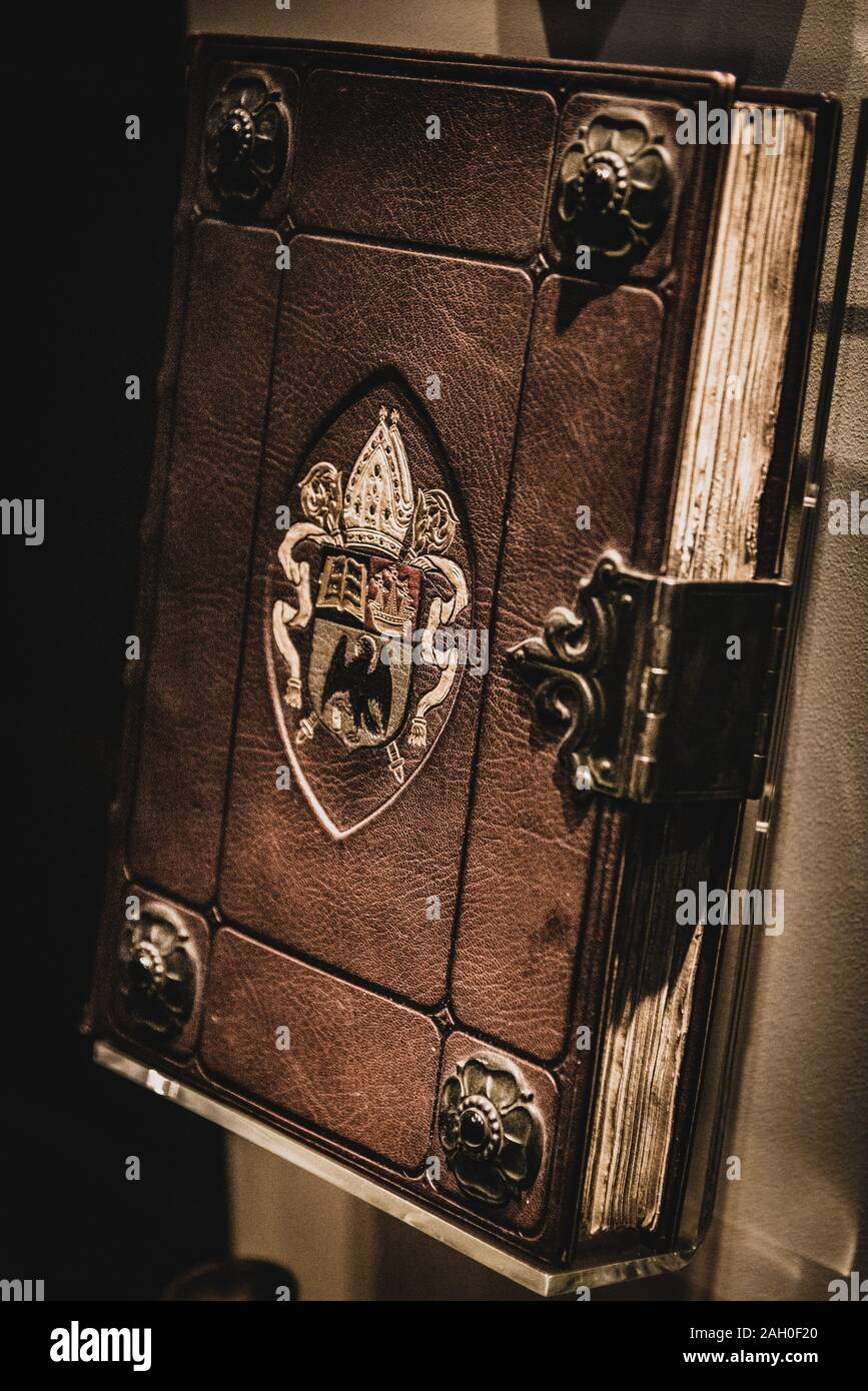 Aged brown leather book with embossed symbols of an eagle, a ship, a ...