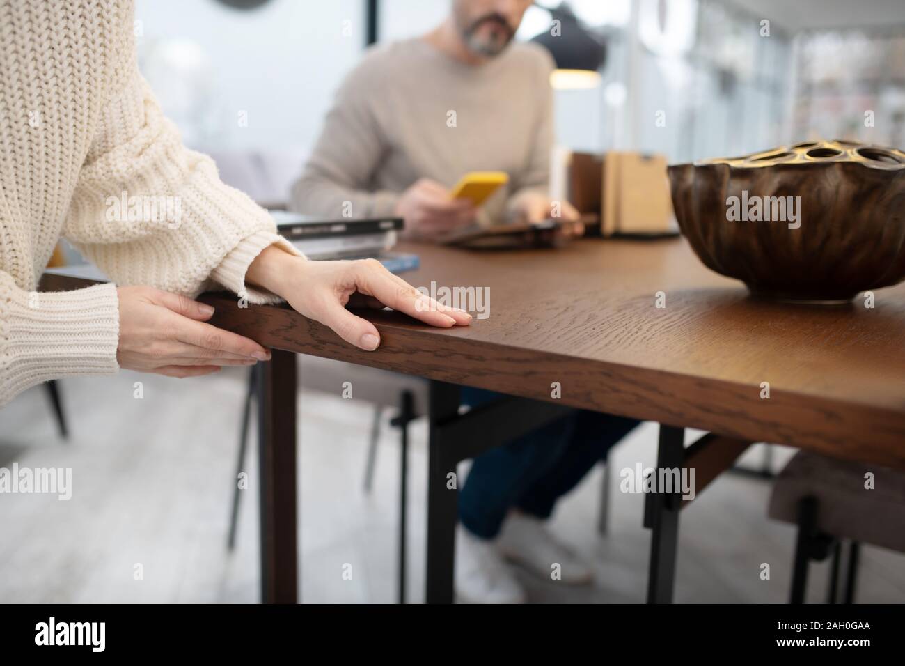 Picture of womans hands touching the table Stock Photo - Alamy
