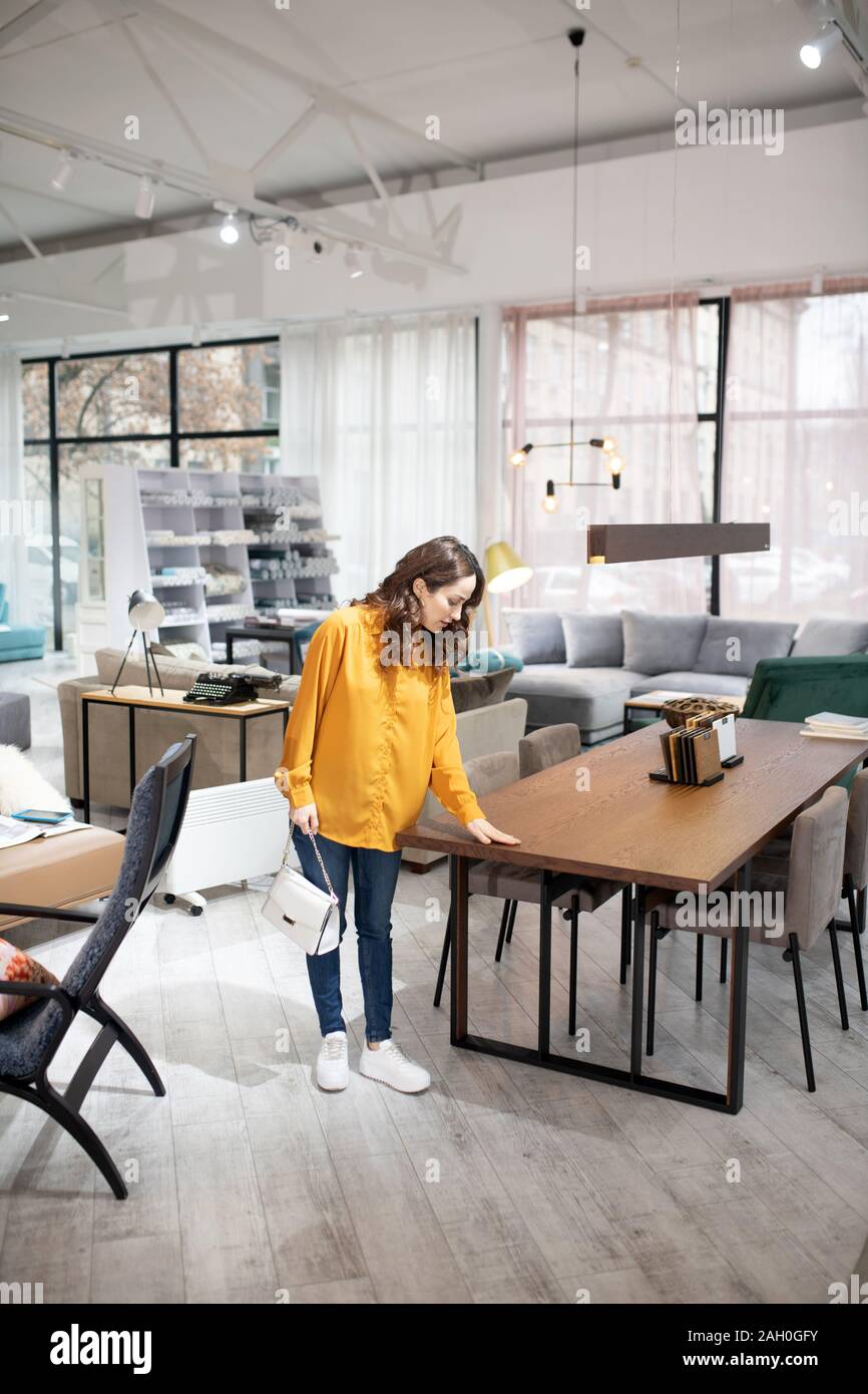Long-haired pretty woman touching the table surface Stock Photo - Alamy