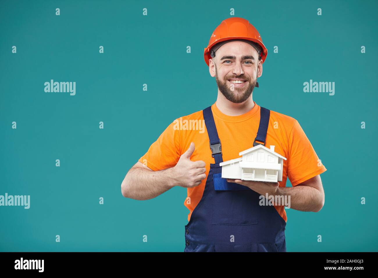 Horizontal studio portrait of construction worker posing on camera with ...