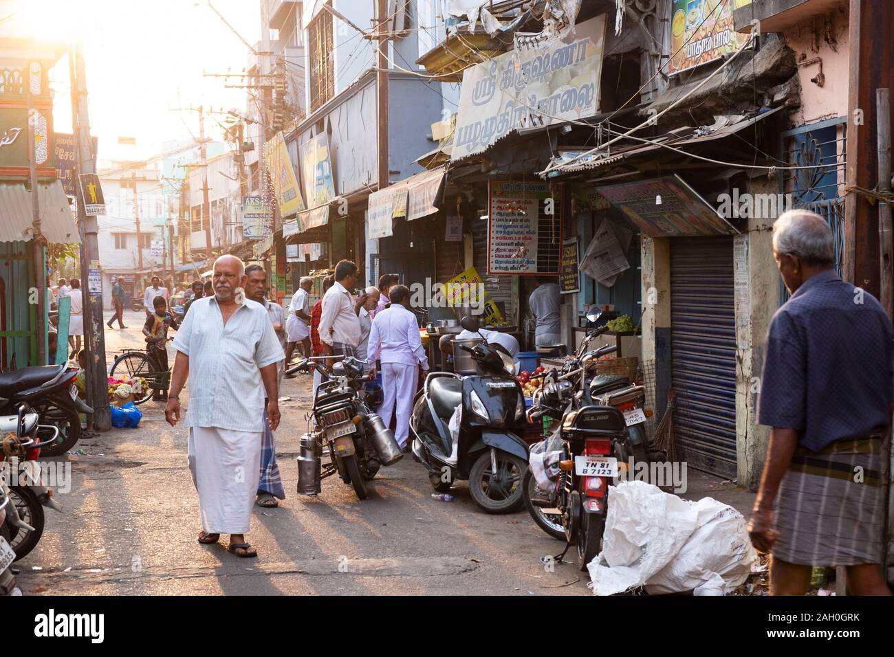 View of people walking in the street at sunrise,Trichy, Tamil Nadu ...