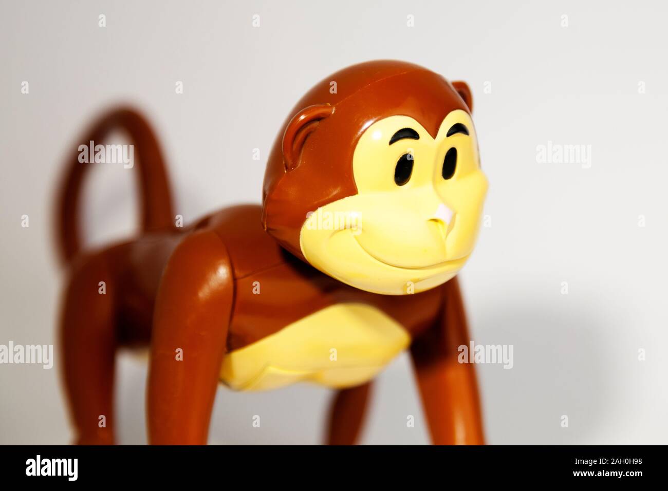 happy crawling toy monkey in plastic on white background Stock Photo ...