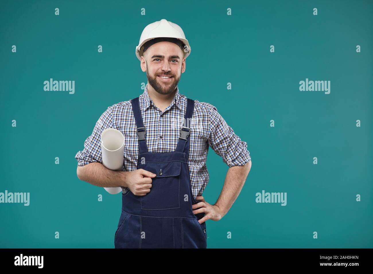 Horizontal studio portrait shot of young adult confident construction ...
