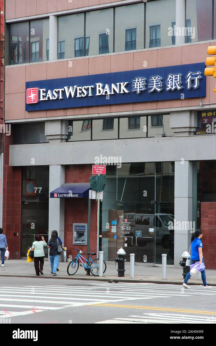 NEW YORK, USA - JULY 1, 2013: People walk by East West Bank in ...