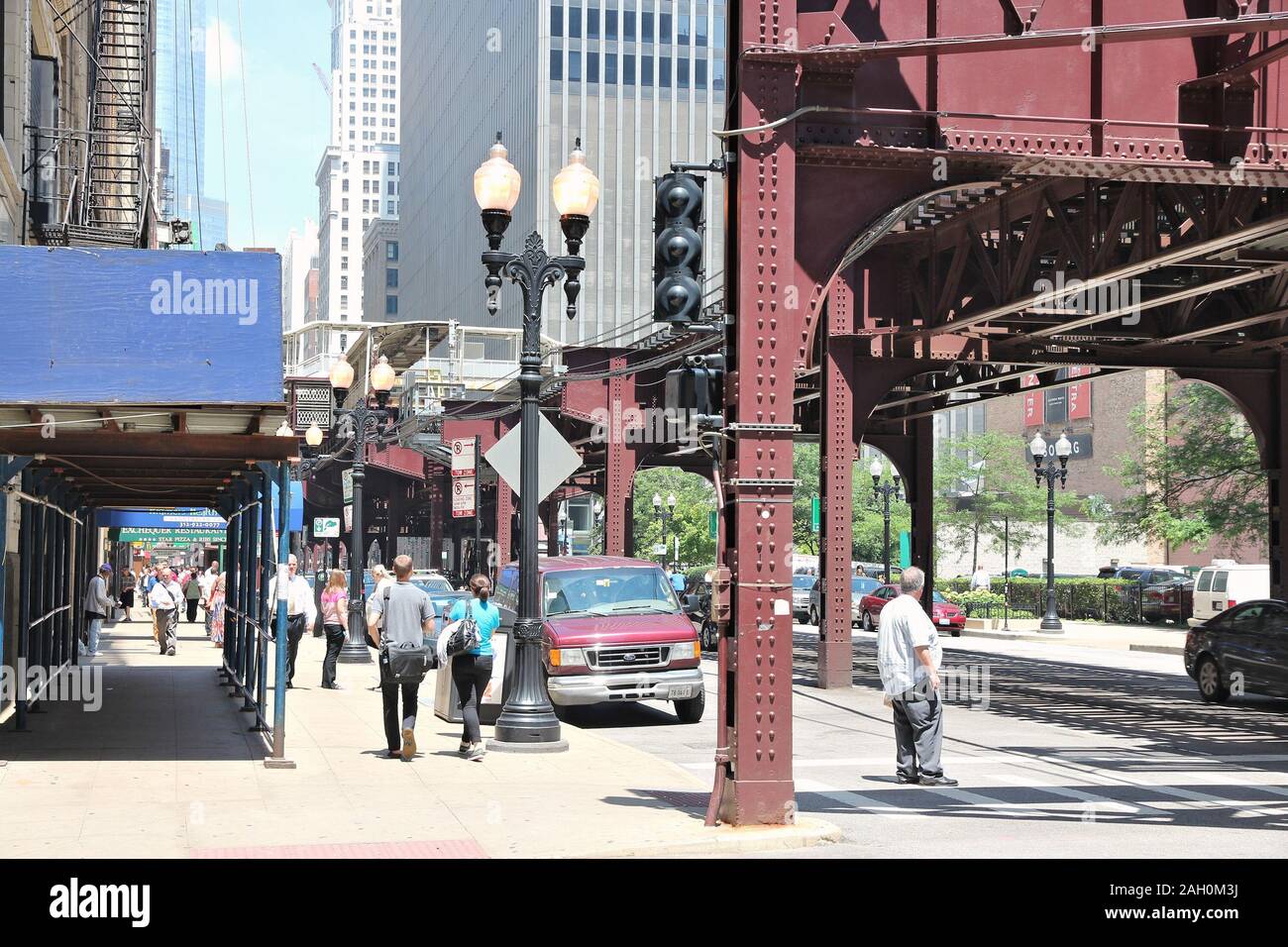 CHICAGO, USA - JUNE 27, 2013: Cars drive below elevated train tracks in ...