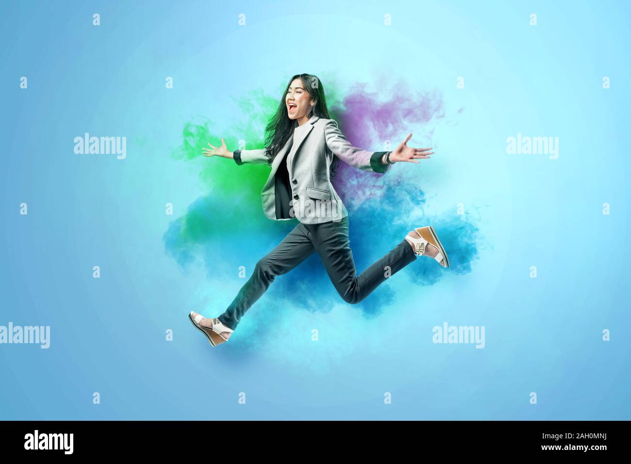 Portrait of Asian businesswoman jumping with colorful background Stock ...