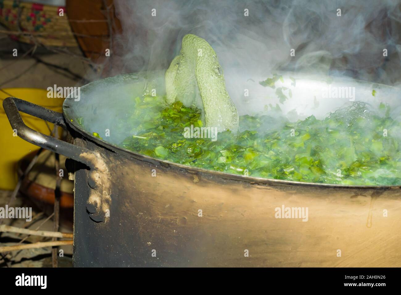 brassica leaves in boiling water,water bubbles are jumping out of the ...
