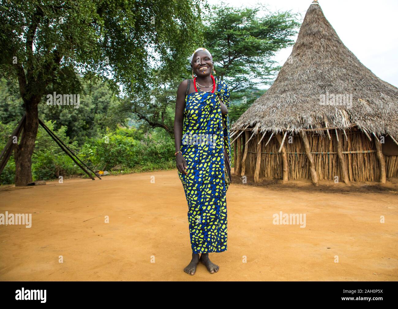 Smiling Larim tribe woman in front of her traditional house, Boya ...