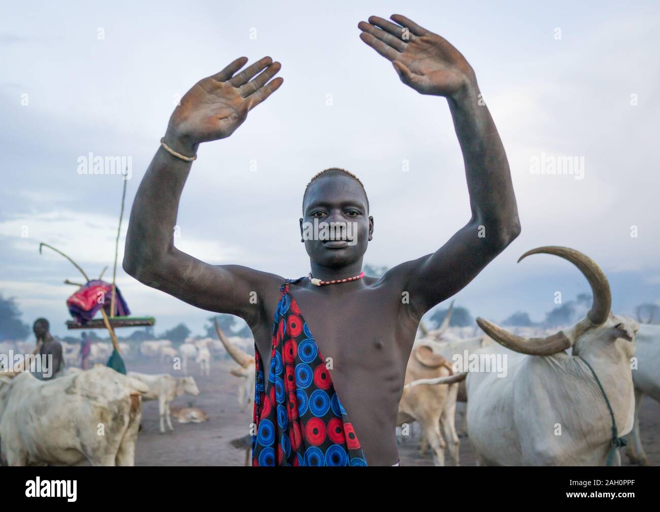 A Mundari tribe man mimics the position of horns of his favourite cow, Central Equatoria ...