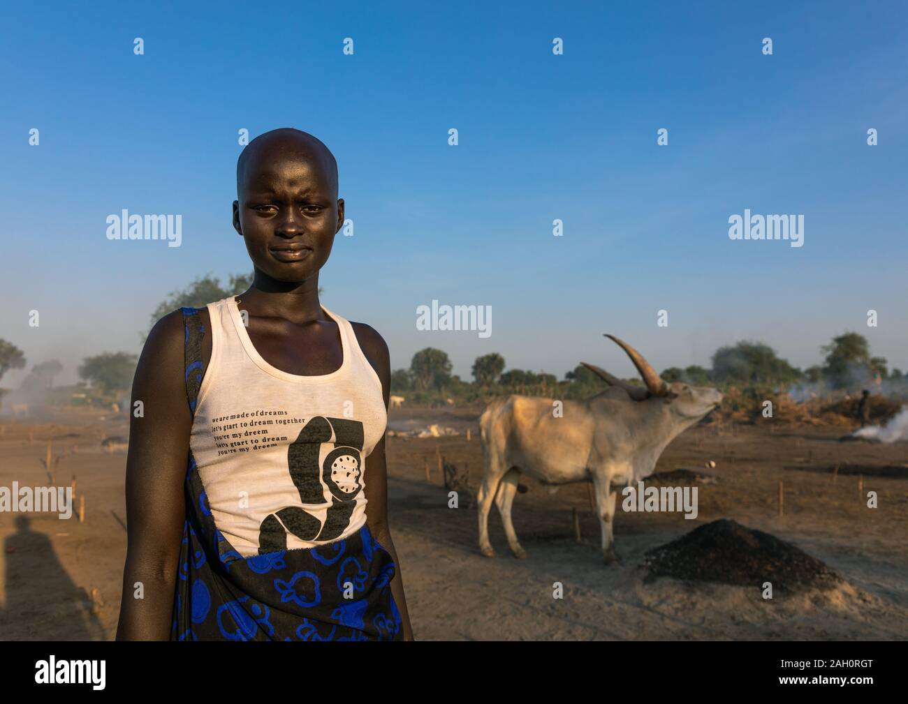 Mundari tribe women with her long horns cows in a camp, Central Equatoria, Terekeka, South Sudan ...