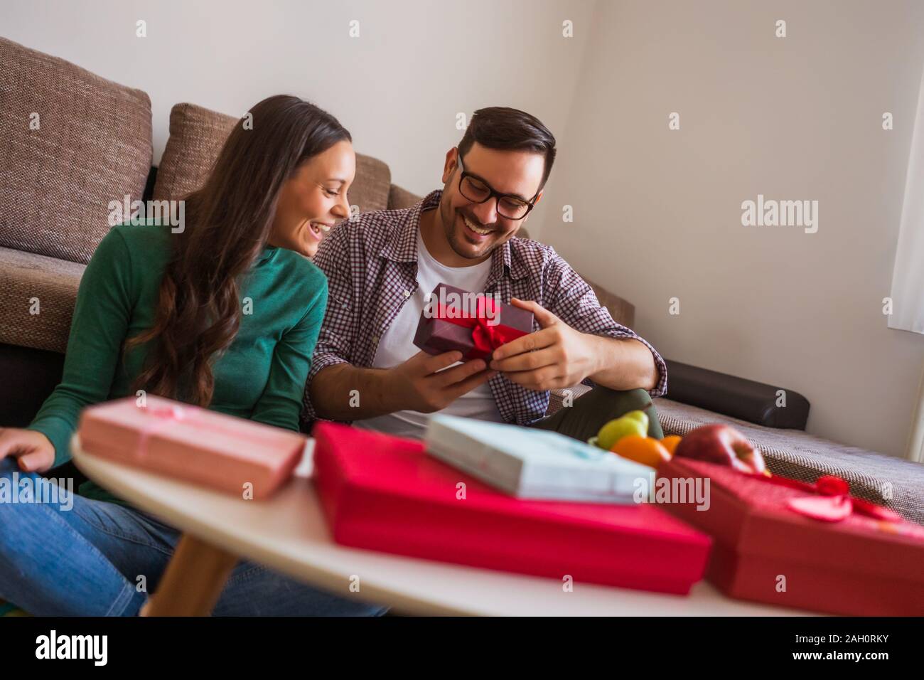 Surprised young woman opening gifts hi-res stock photography and images ...