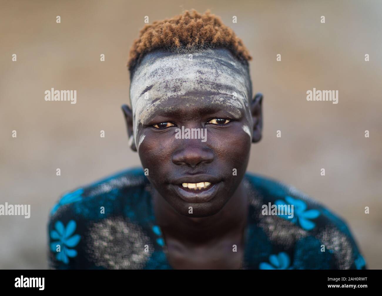Mundari tribe boy covered in ash and hair dyed in orange with urine cow, Central Equatoria ...