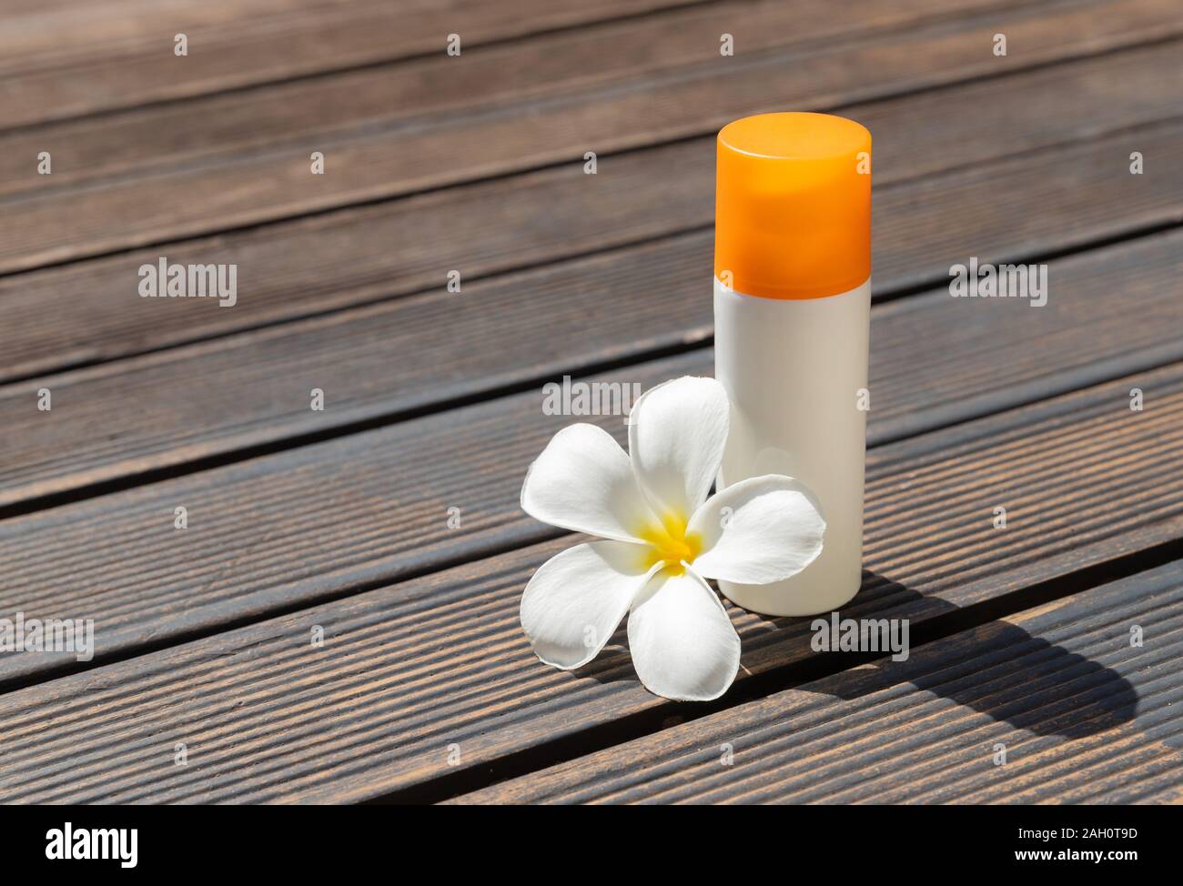 Sunscreen cream and tropical flower near swimming pool Stock Photo - Alamy