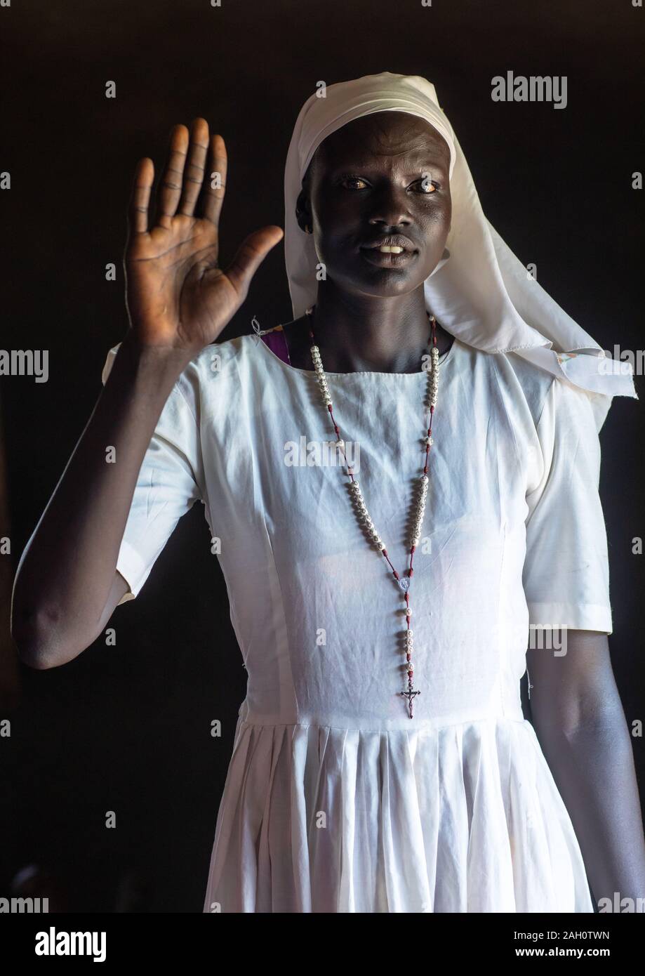 Portrait on a Mundari tribe nun with hand raised, Central Equatoria, Terekeka, South Sudan Stock ...