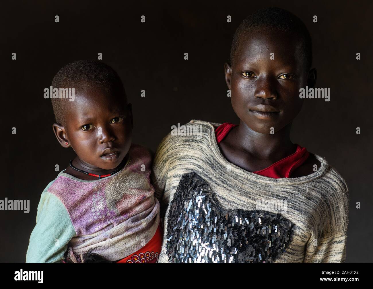 Portrait of a Mundari tribe boy with a child, Central Equatoria, Terekeka, South Sudan Stock ...
