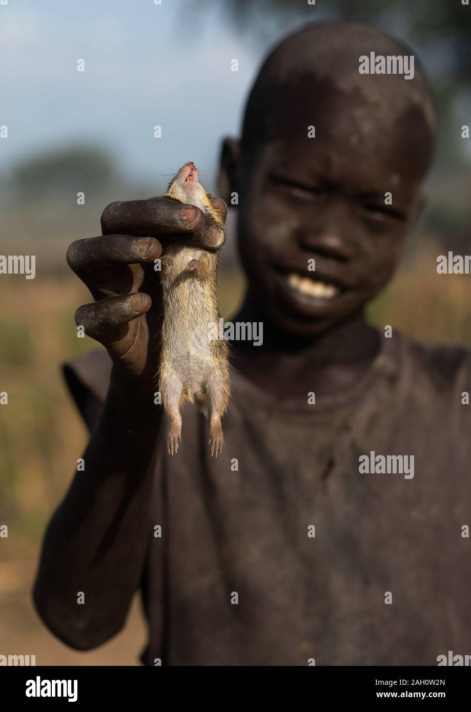 Mundari tribe boy showing a rat he hunted, Central Equatoria, Terekeka ...