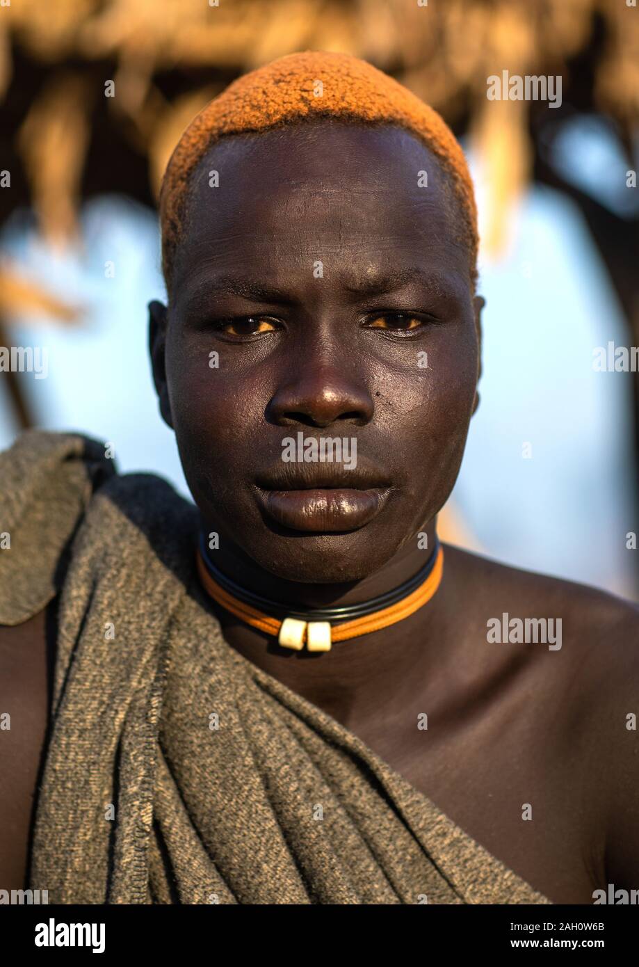 Portrait of a Mundari tribe man with hair dyed in orange with cow urine, Central Equatoria ...
