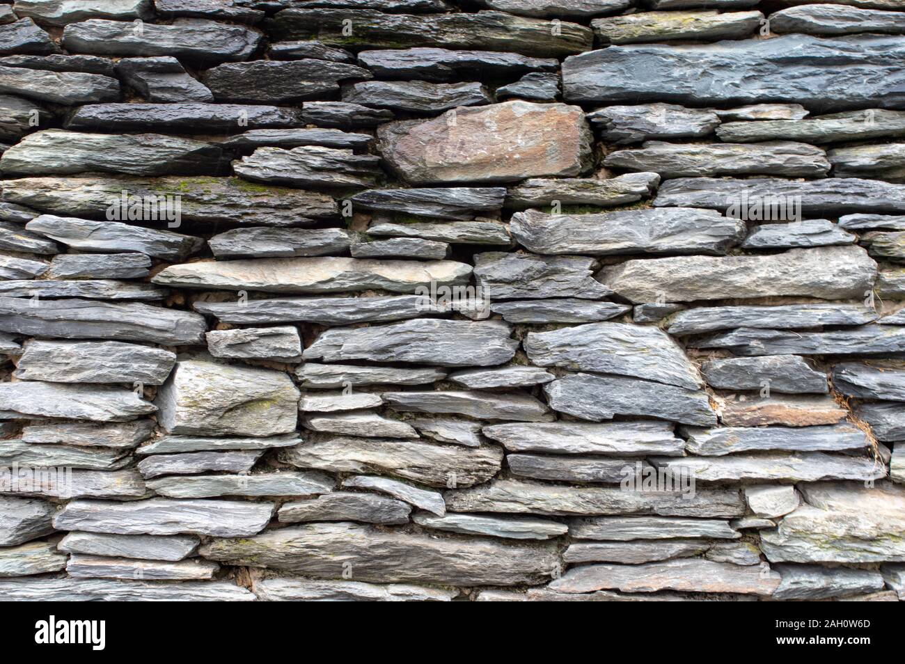 A jagged stone wall background with different shades of grey Stock ...
