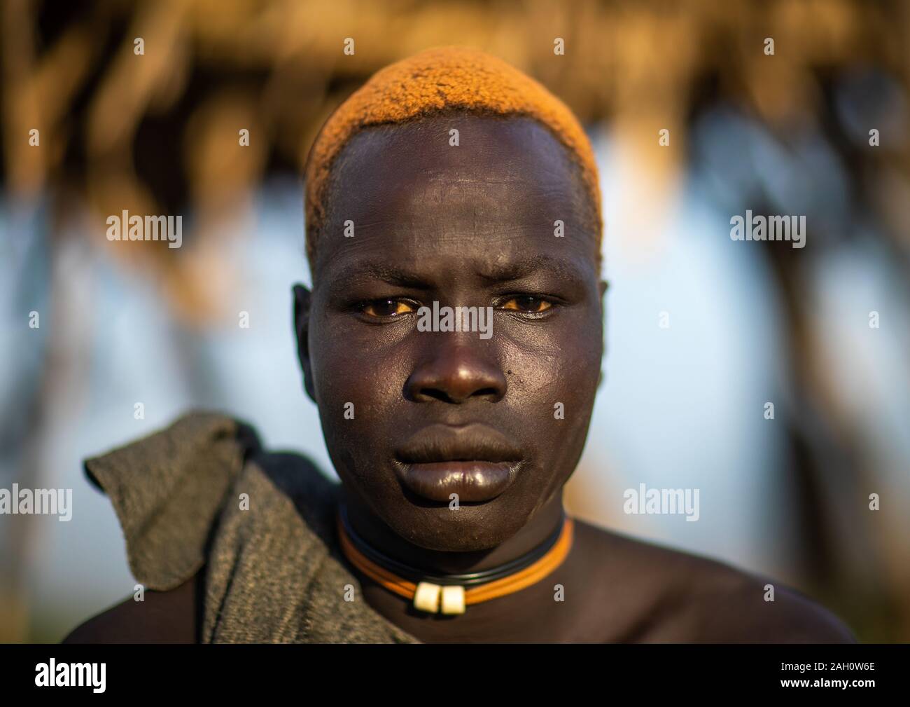 Portrait of a Mundari tribe man with hair dyed in orange with cow urine, Central Equatoria ...