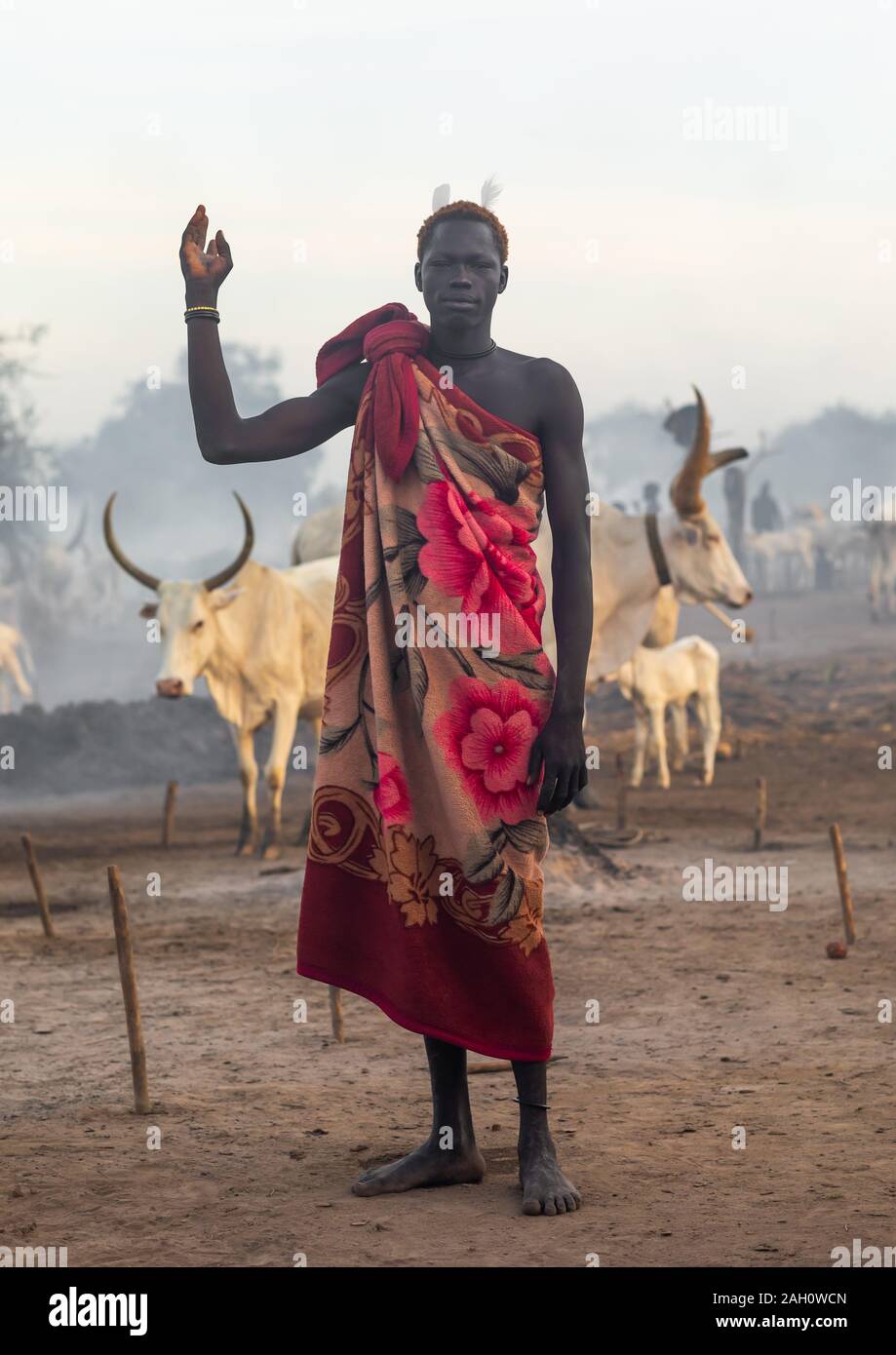 A Mundari tribe man mimics the position of horns of his favourite cow, Central Equatoria ...