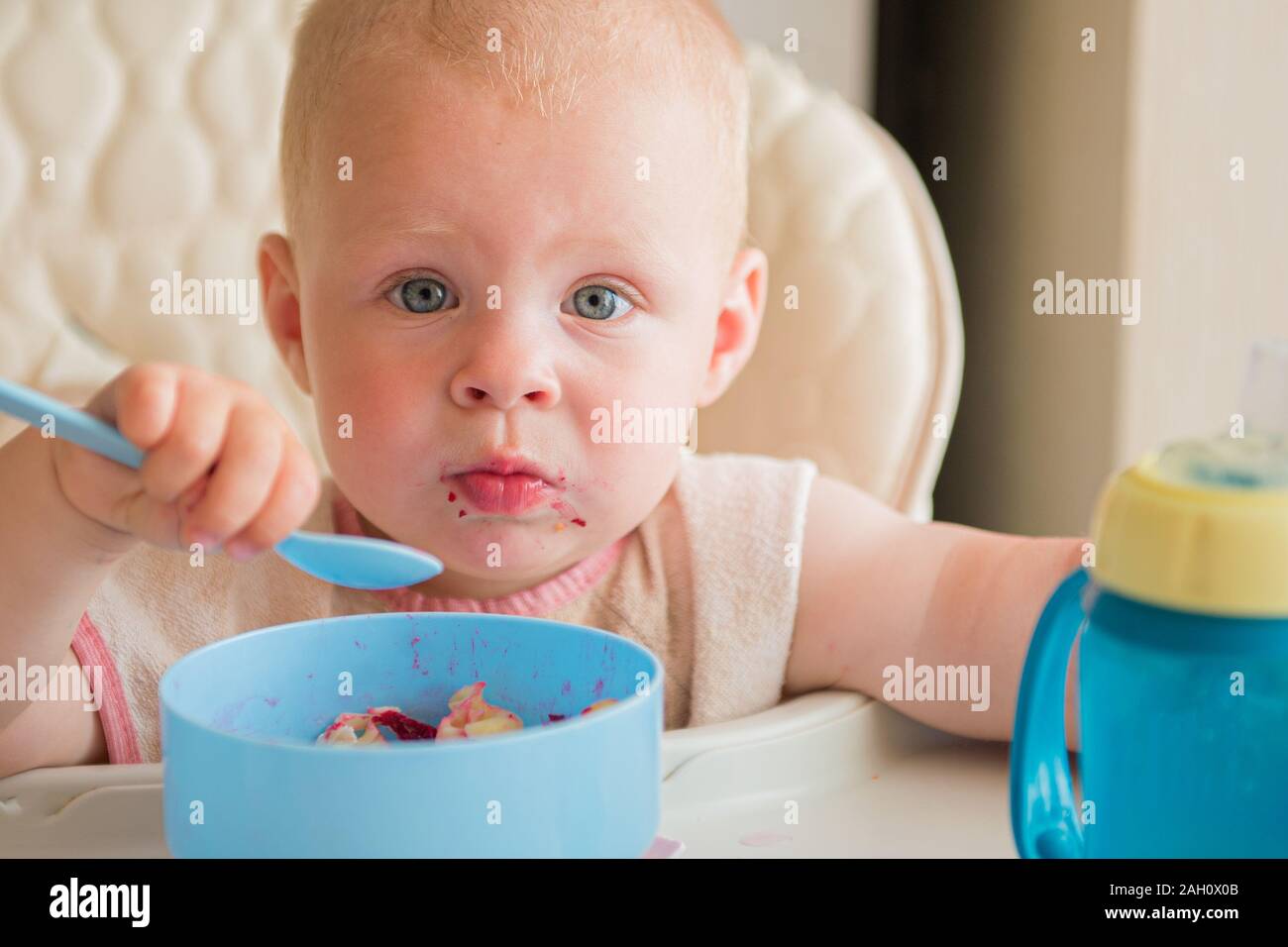 Boy learning to eat. cute messy baby eating vegetables with spoon by ...