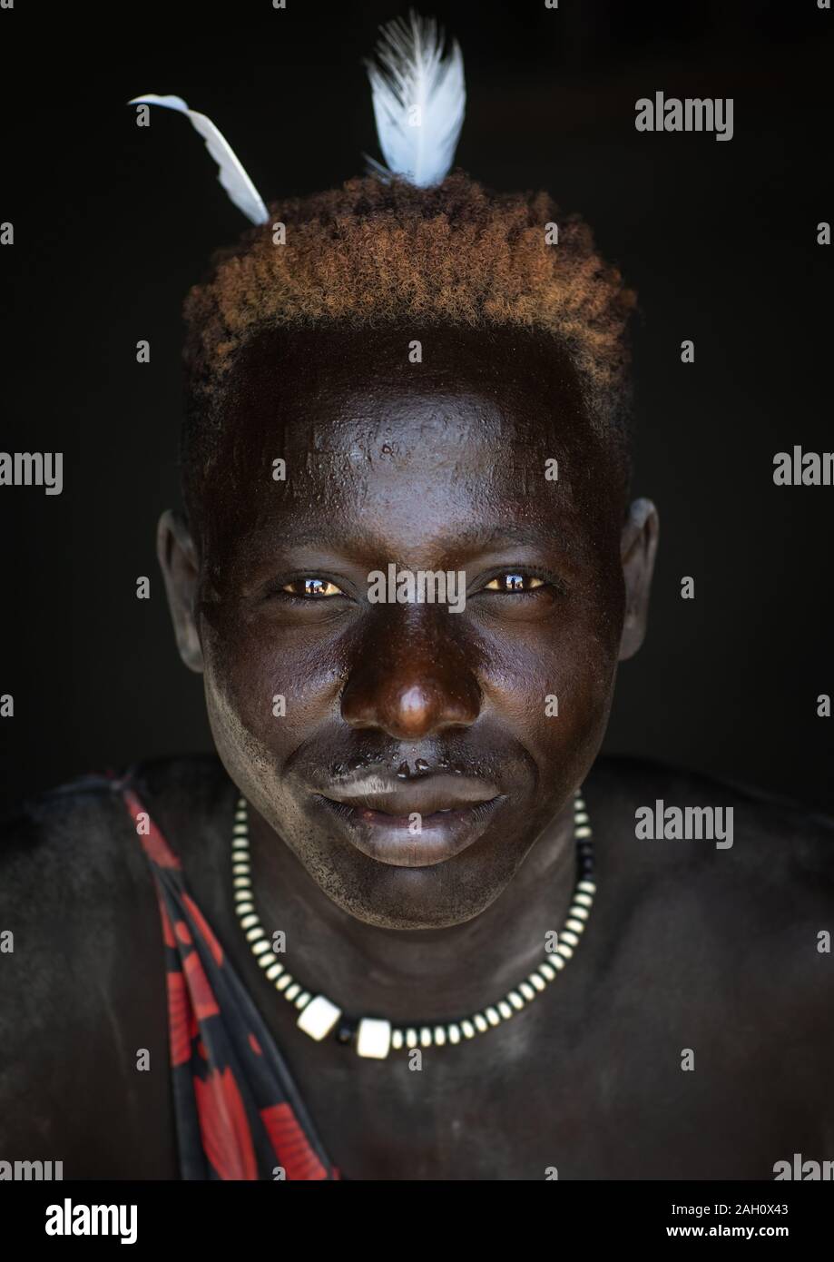 Portrait of a Mundari tribe man with hair dyed in orange with cow urine ...