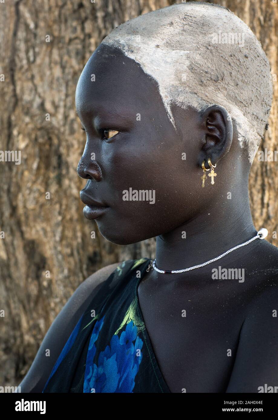 Portrait of a beautiful Mundari young woman with ash on the head to dye her hair in red, Central ...