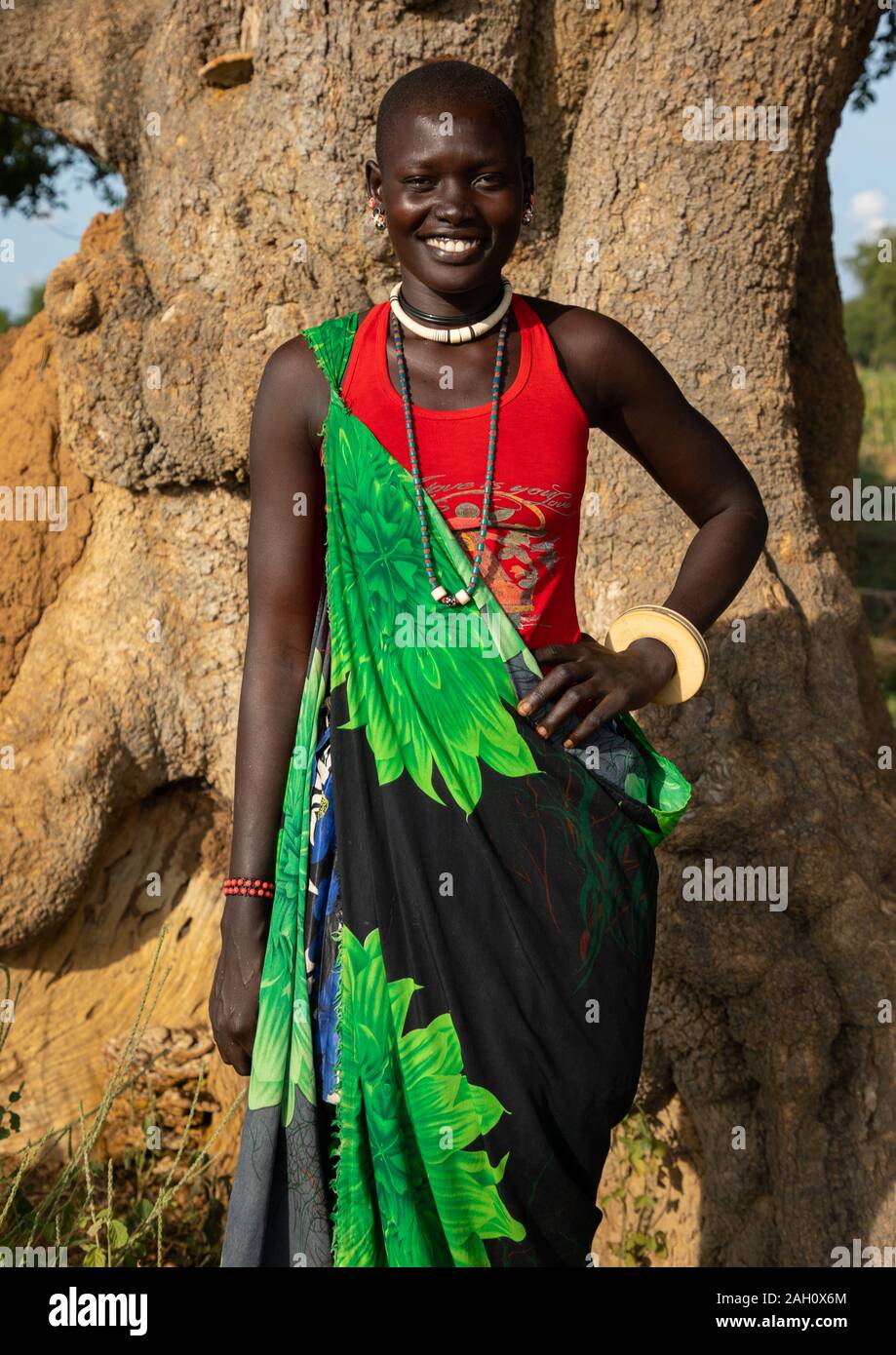 Portrait of a smiling Mundari tribe woman in front of a tree, Central Equatoria, Terekeka, South ...