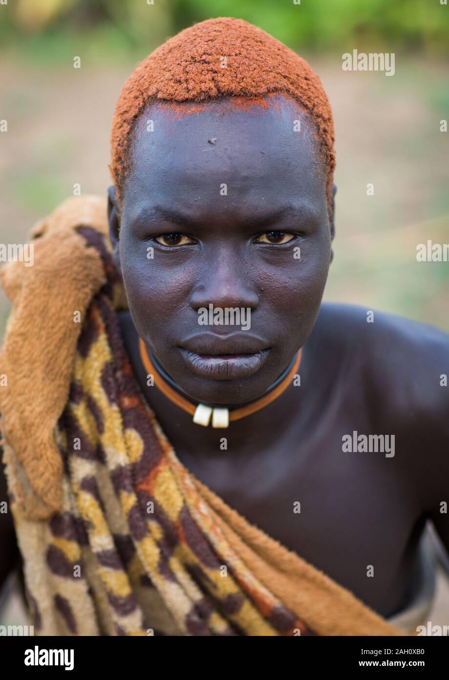 Portrait of a Mundari tribe man with hair dyed in orange with cow urine, Central Equatoria ...