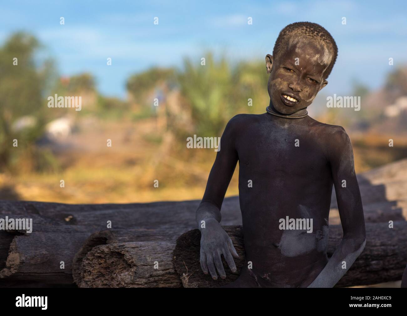Mundari tribe boy covered in ash to protect from the mosquitoes and flies, Central Equatoria ...