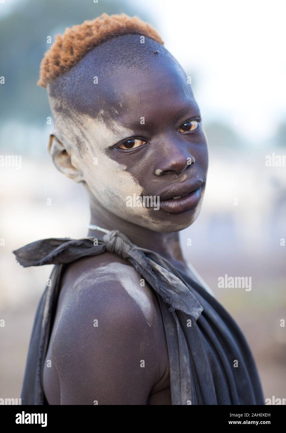 Mundari tribe boy covered in ash to protect from the mosquitoes and flies, Central Equatoria ...