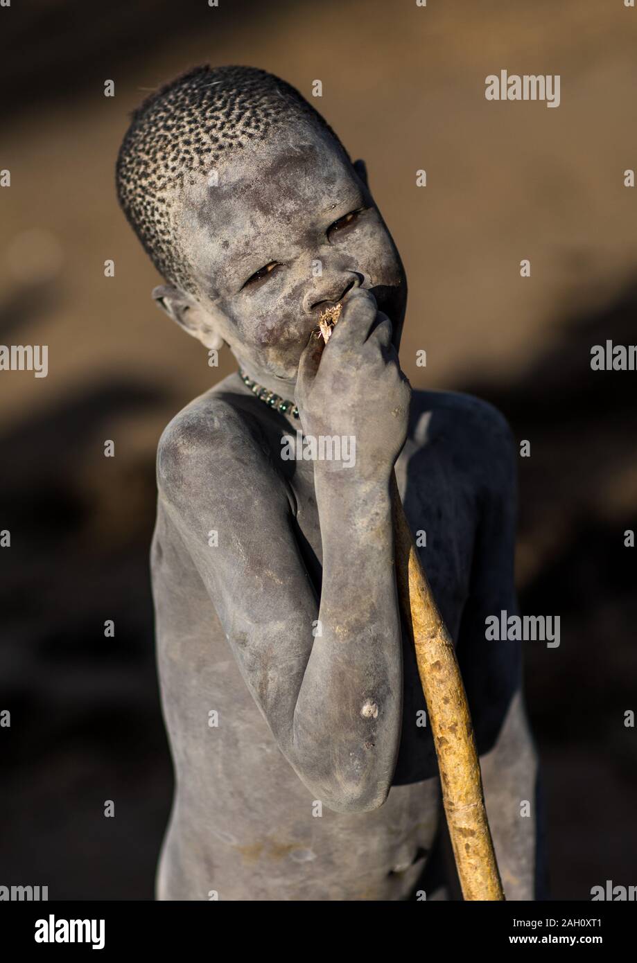 Smiling Mundari tribe boy covered in ash to repel flies and mosquitoes, Central Equatoria ...