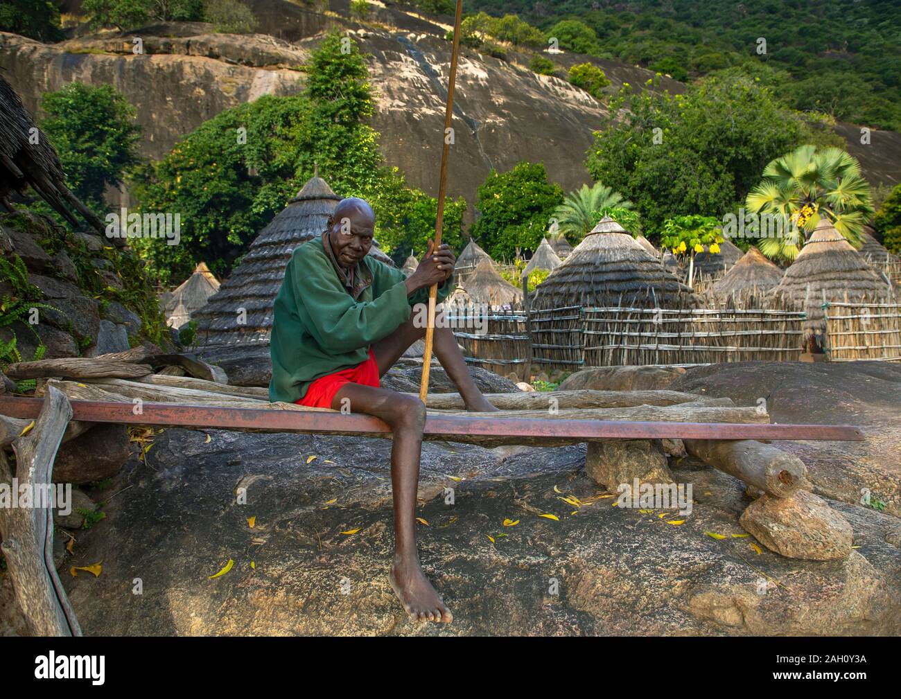 Lotuko tribe man resting on a wooden bed, Central Equatoria, Illeu ...
