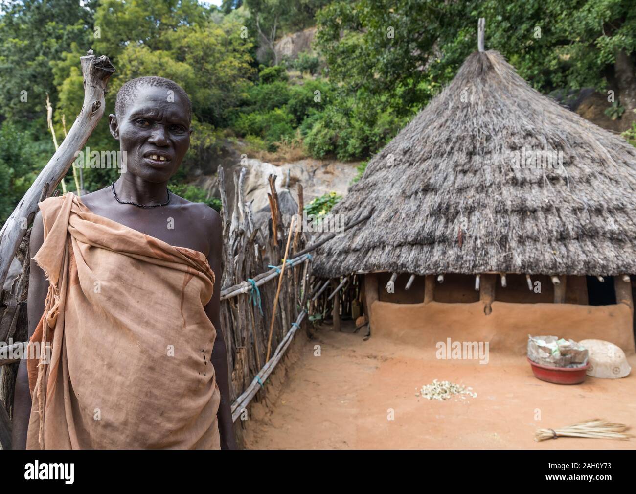 Woman in front of a Lotuko tribe thatched house, Central Equatoria ...