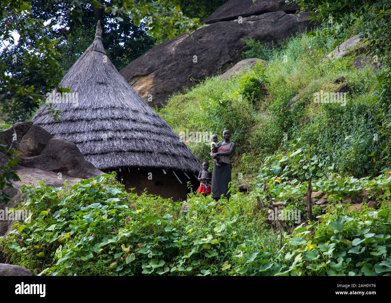 Family in front of a Lotuko tribe thatched house, Central Equatoria ...